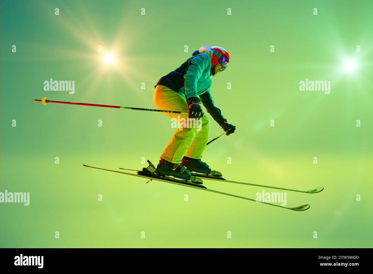 Female skier performing jump, dynamic body posture in neon green ...