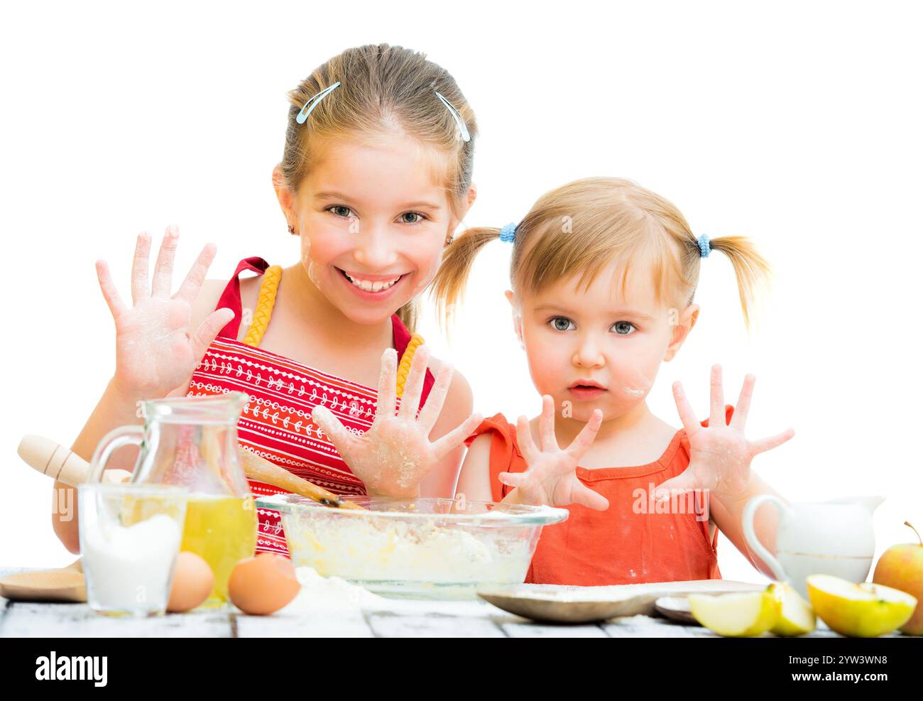 cute little sisters baking on kitchen and shows hands on a white ...