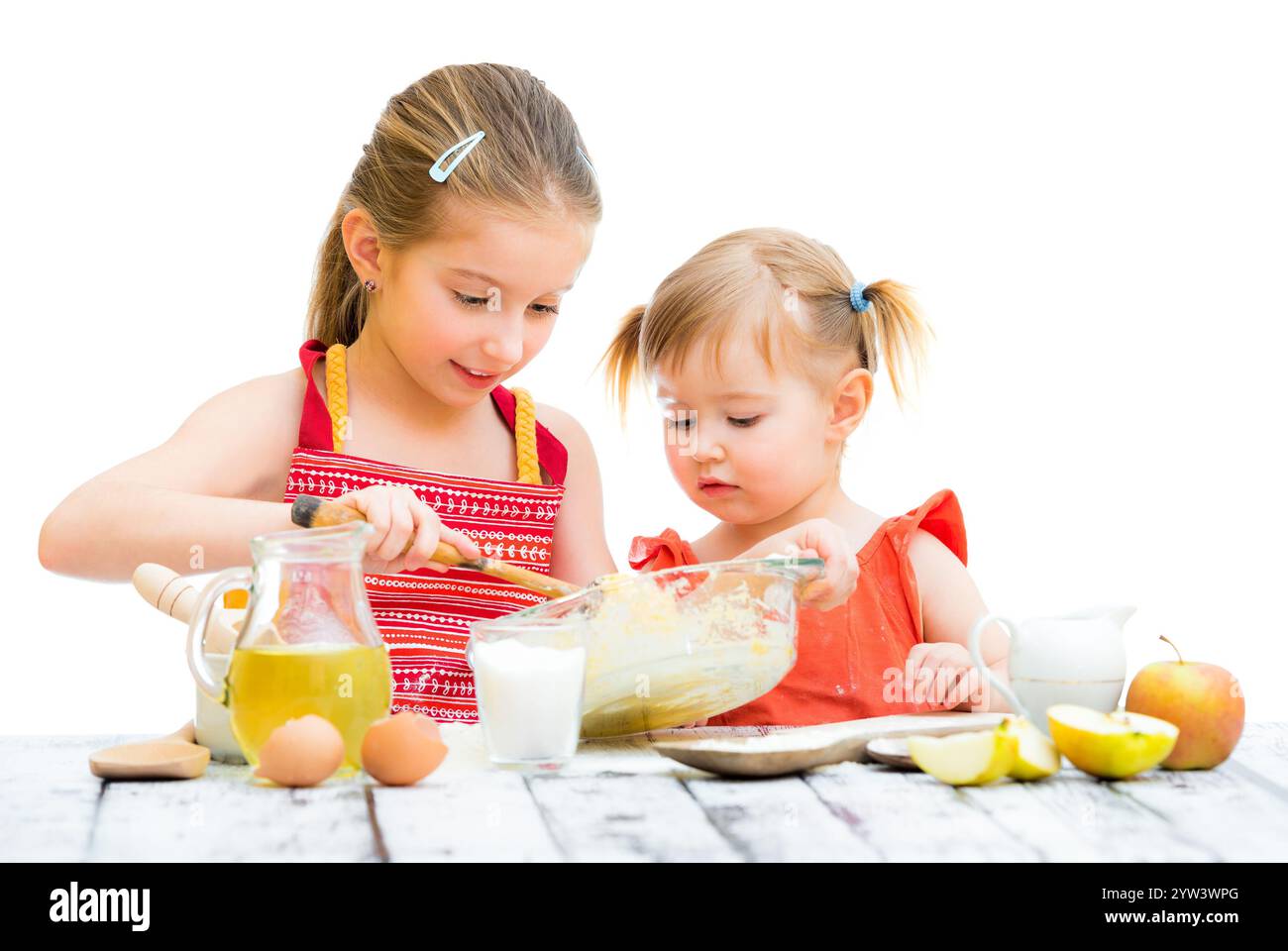 two cute little sisters baking on a white background Stock Photo - Alamy