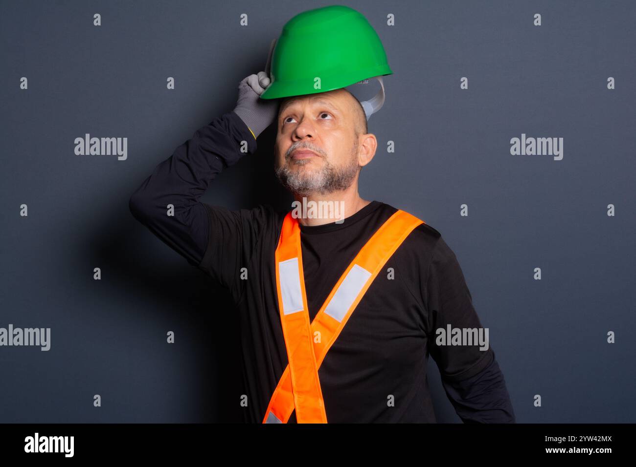Photo of a civil worker in gloves and reflective vest putting on ...