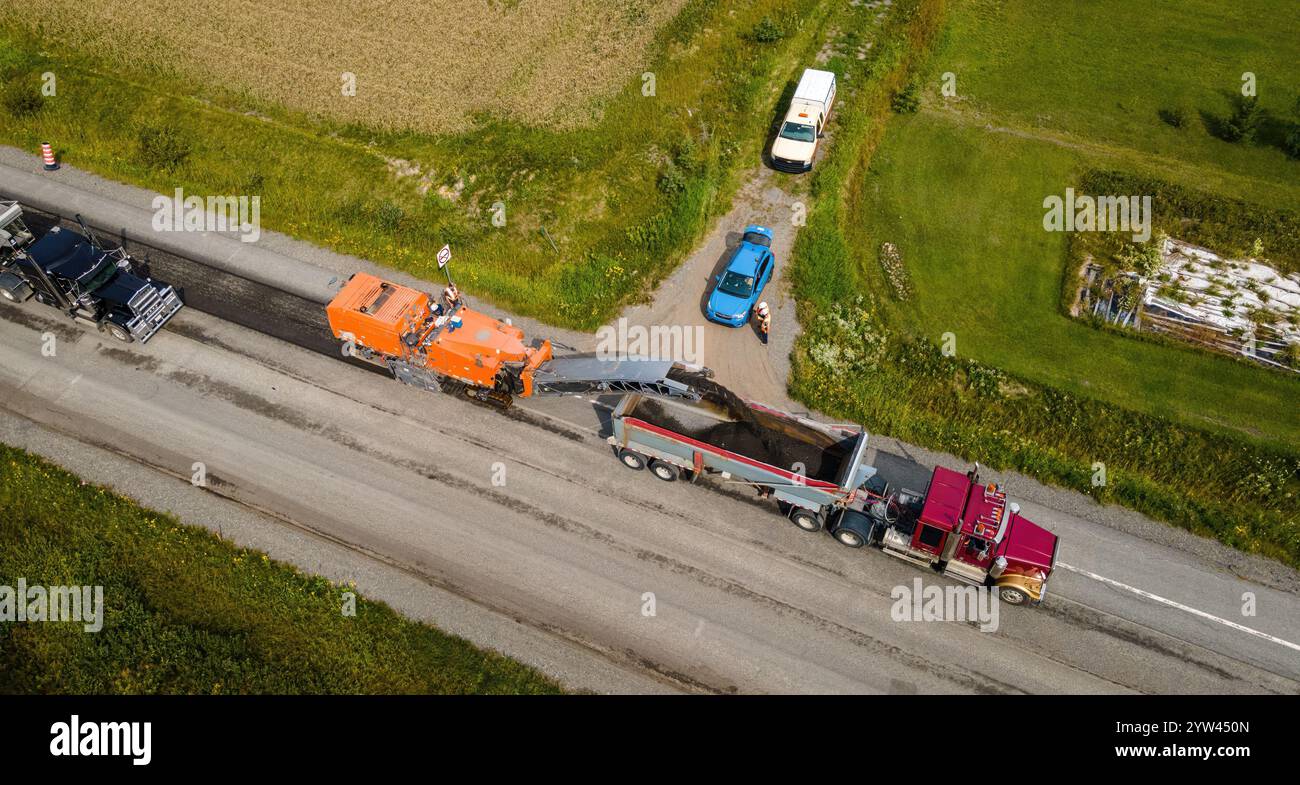 Asphalt planing on a road, with two dump trucks Stock Photo - Alamy