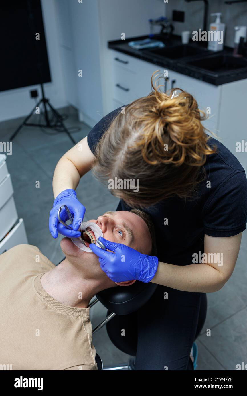 Modern stomatological office. An orthodontist installs braces ...