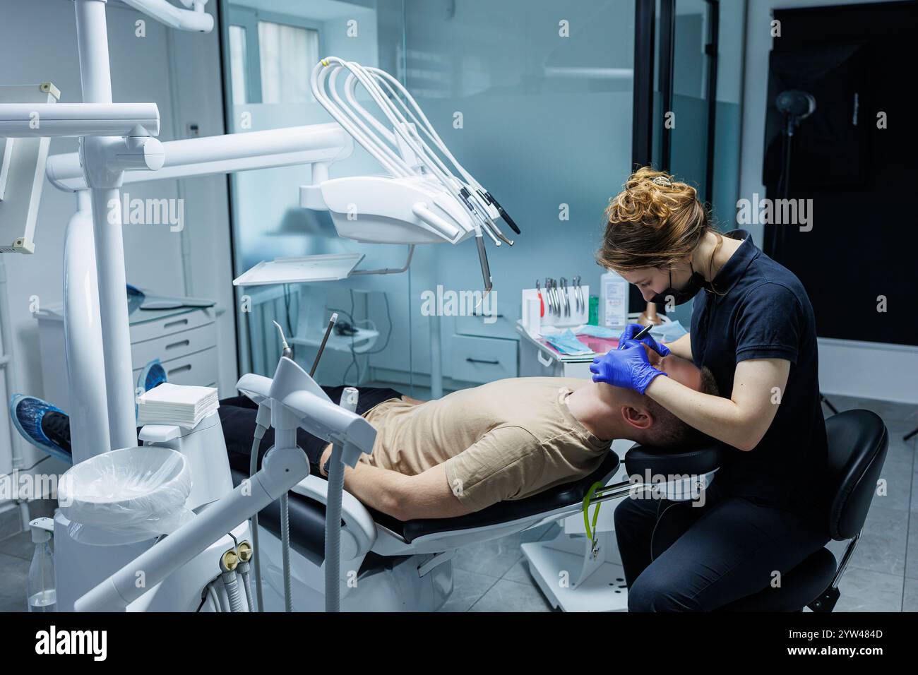 Modern stomatological office. An orthodontist installs braces ...
