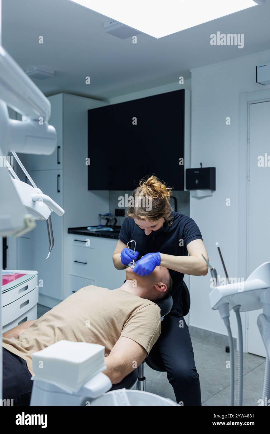 Modern stomatological office. An orthodontist installs braces ...