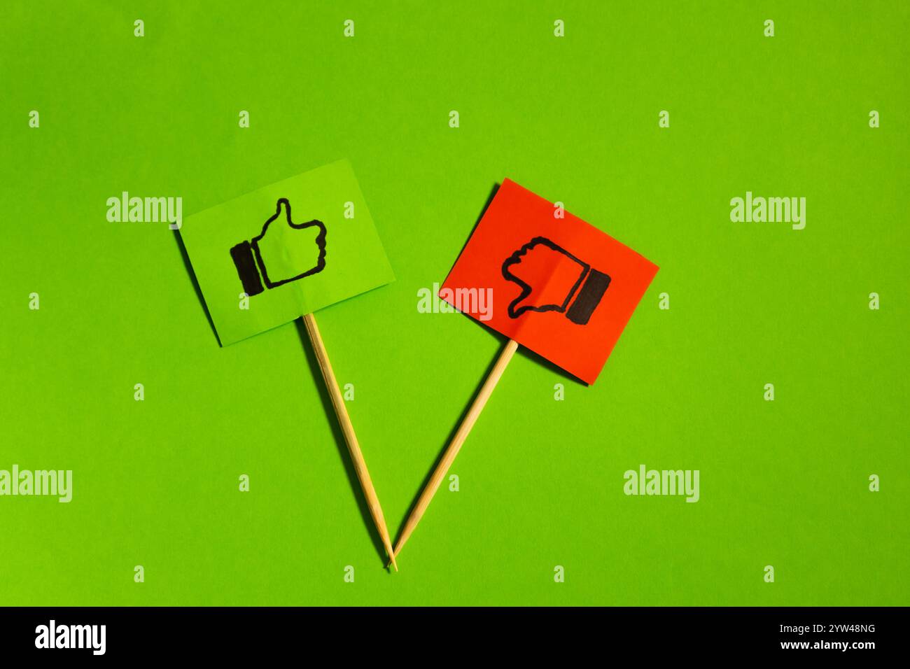 Green and red flags with thumbs up and thumbs down on a green ...
