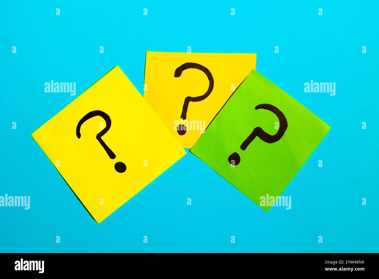 Three sticky notes with question marks on a blue background, question ...