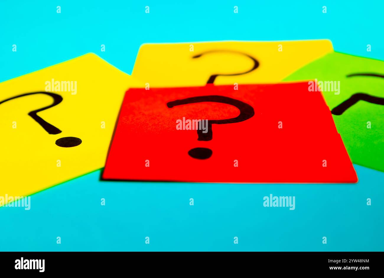 Close up of multi colored sticky papers with question marks on blue ...
