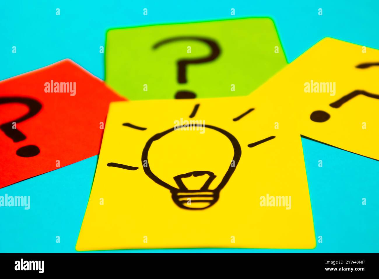 Close up of sticky papers with question marks and idea bulb drawn on ...