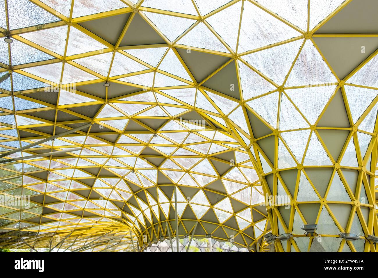 Modern geometric yellow lattice roof structure with a repetitive ...