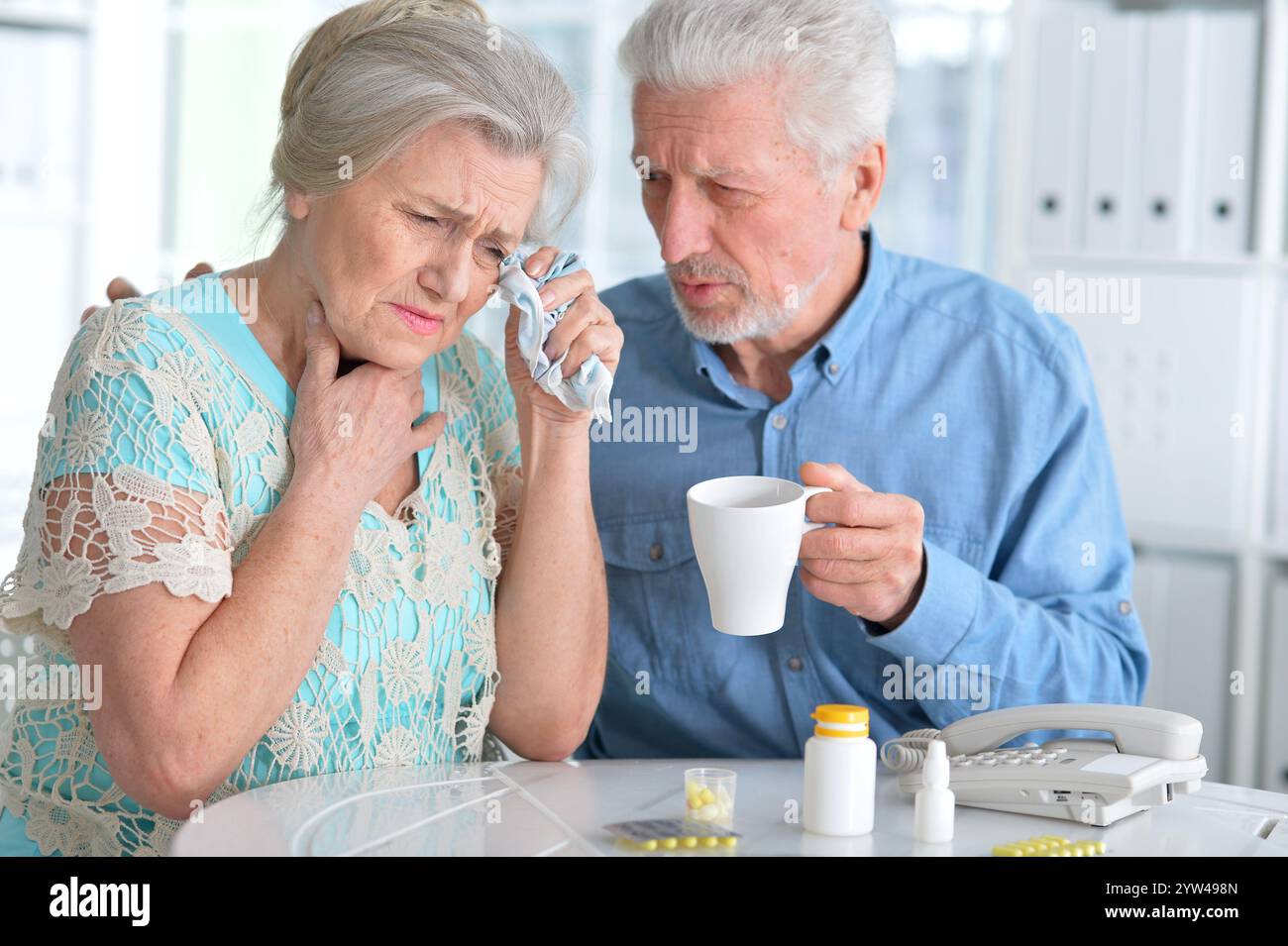 An elderly couple is sick and takes medication at home Stock Photo - Alamy