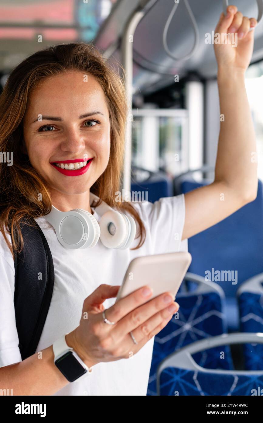 Vertical portrait of woman inside the bus. Public transport passenger ...