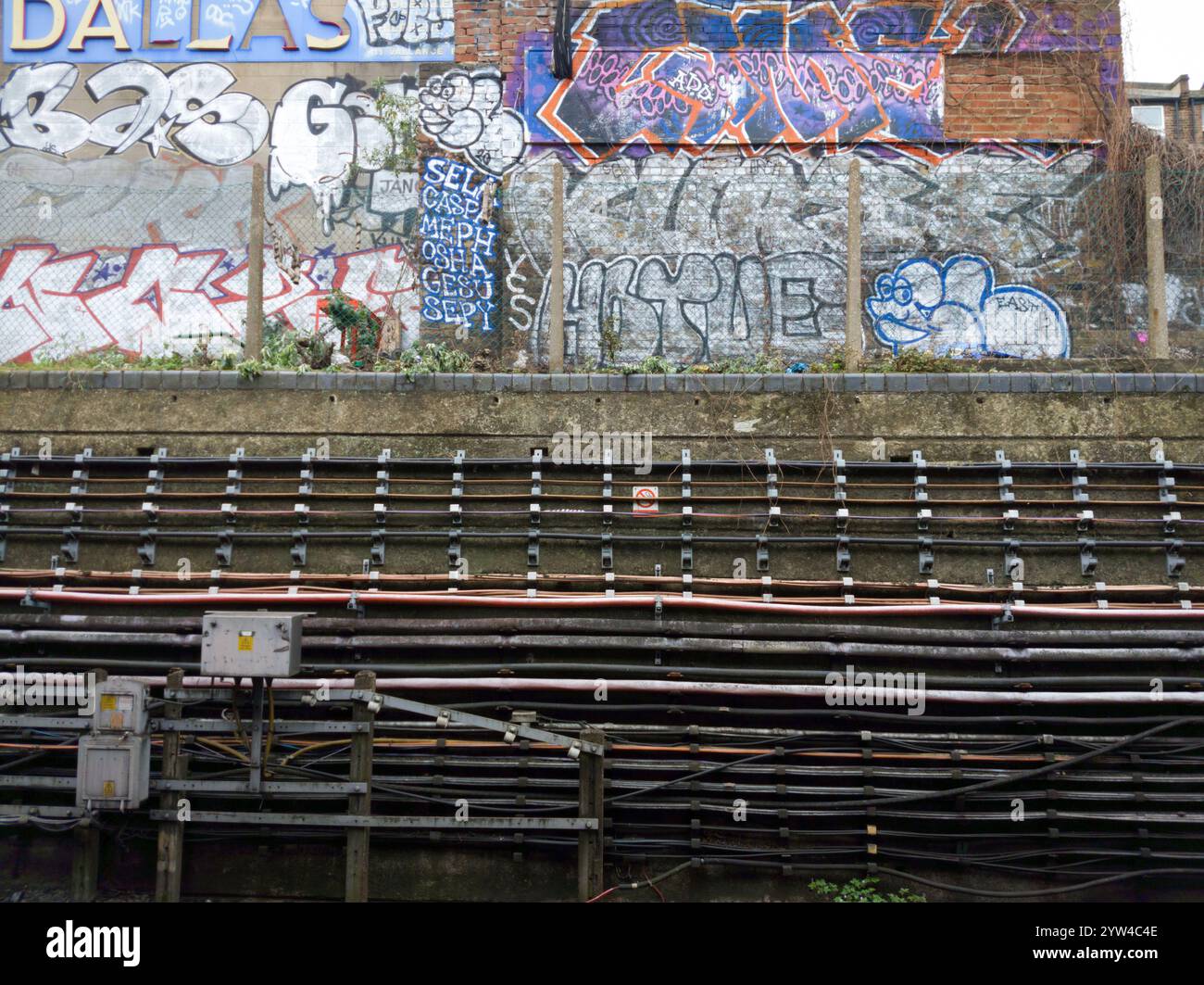 Graffiti on wall of brick building by side of railway track in South ...