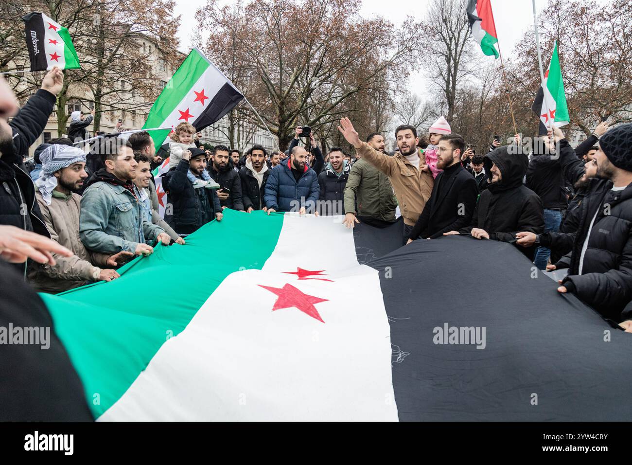 People march with a large Free Syrian Army flag during the celebration ...