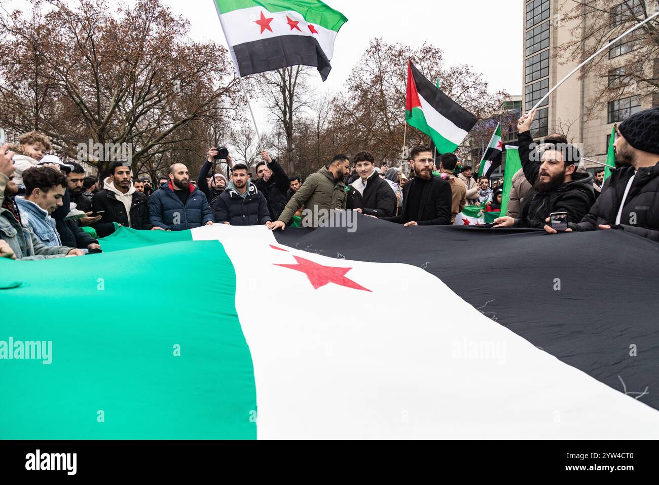 People march with a large Free Syrian Army flag during the celebration ...