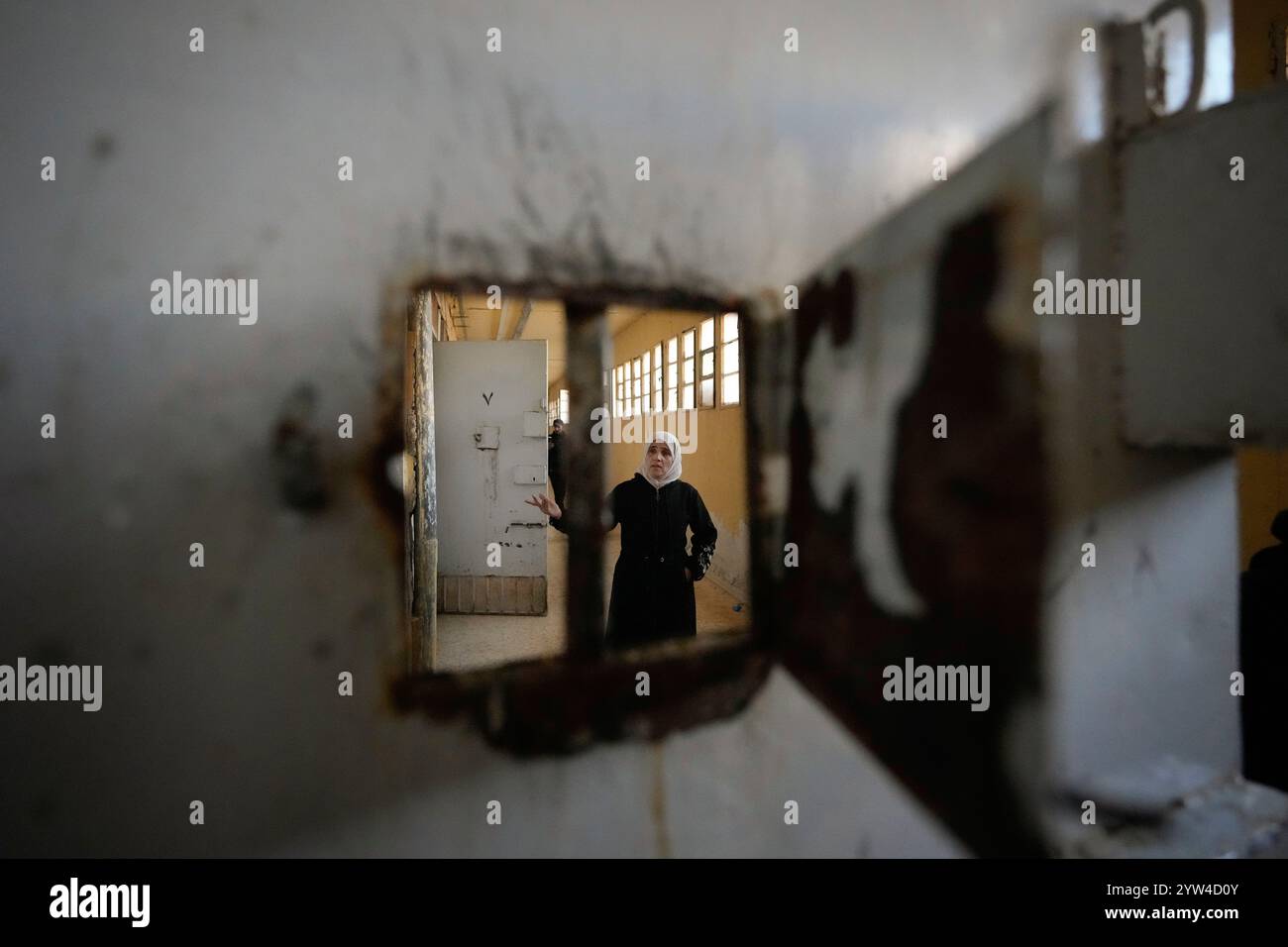 A woman examines the cells at the infamous Saydnaya military prison ...