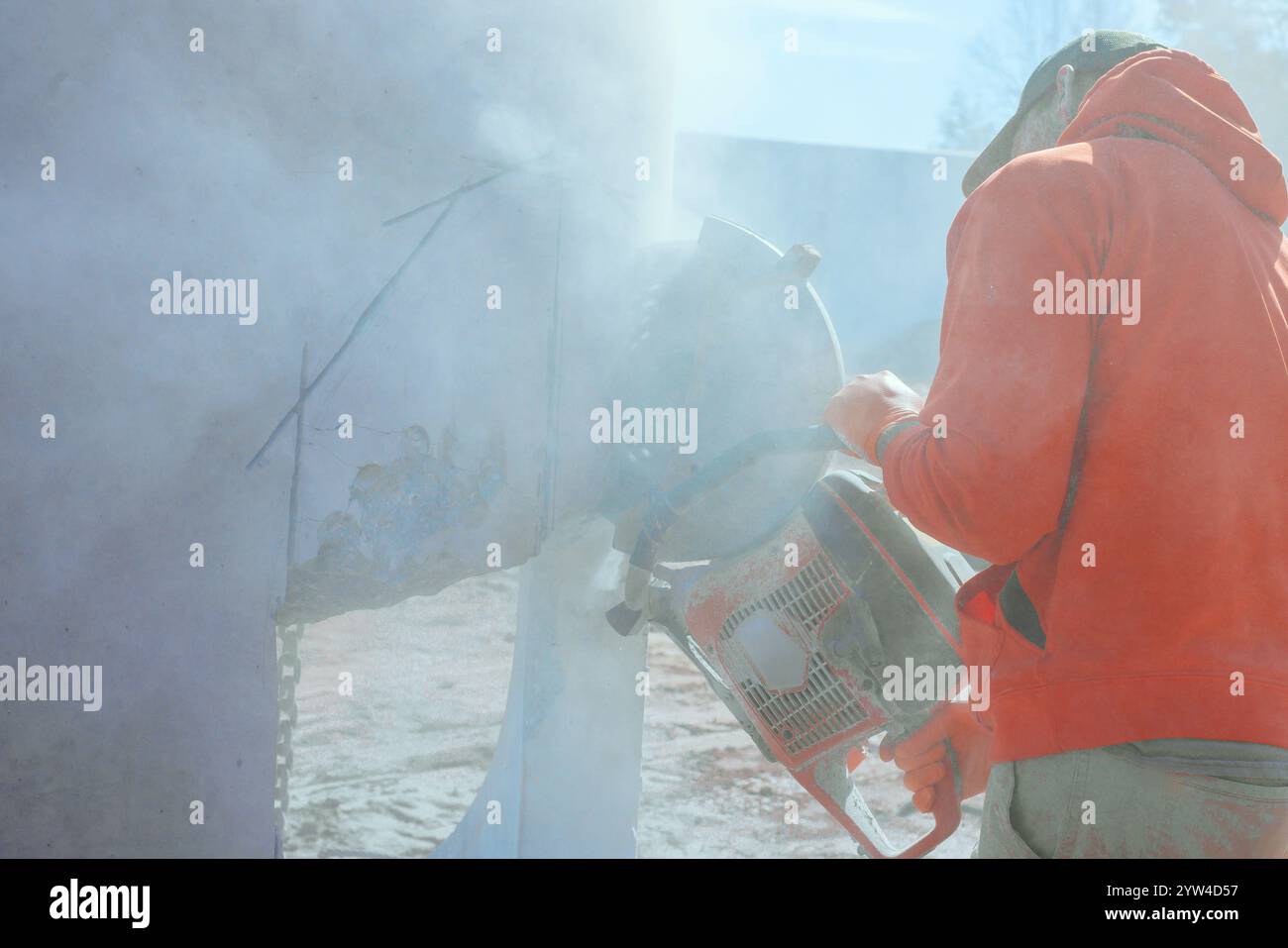 Worker skillfully operates concrete saw, cutting through drainage ...