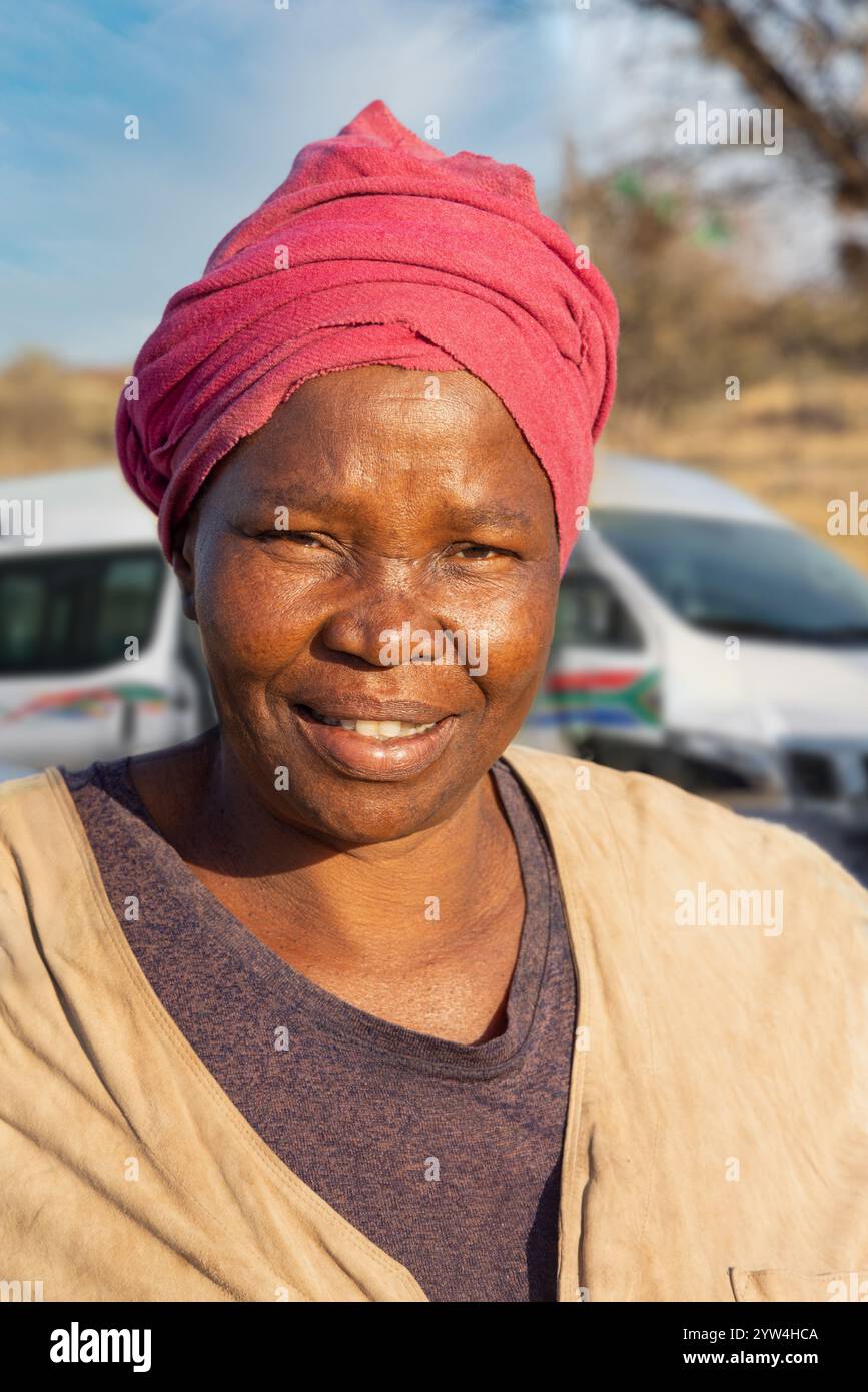 village, portrait of single african woman, waiting in the taxi rank ...