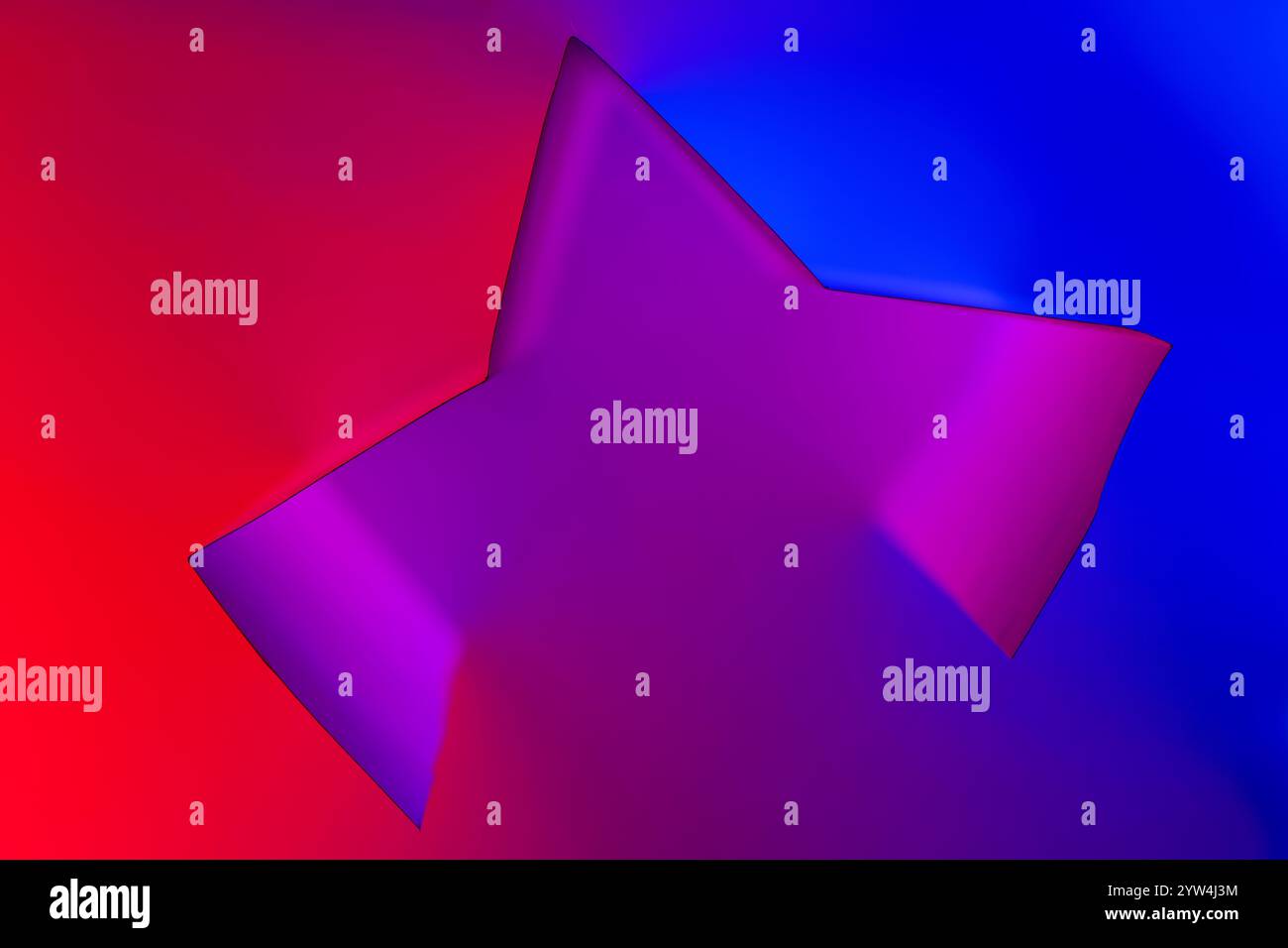 Folded paper illuminated by red and blue coloured lights to create a ...