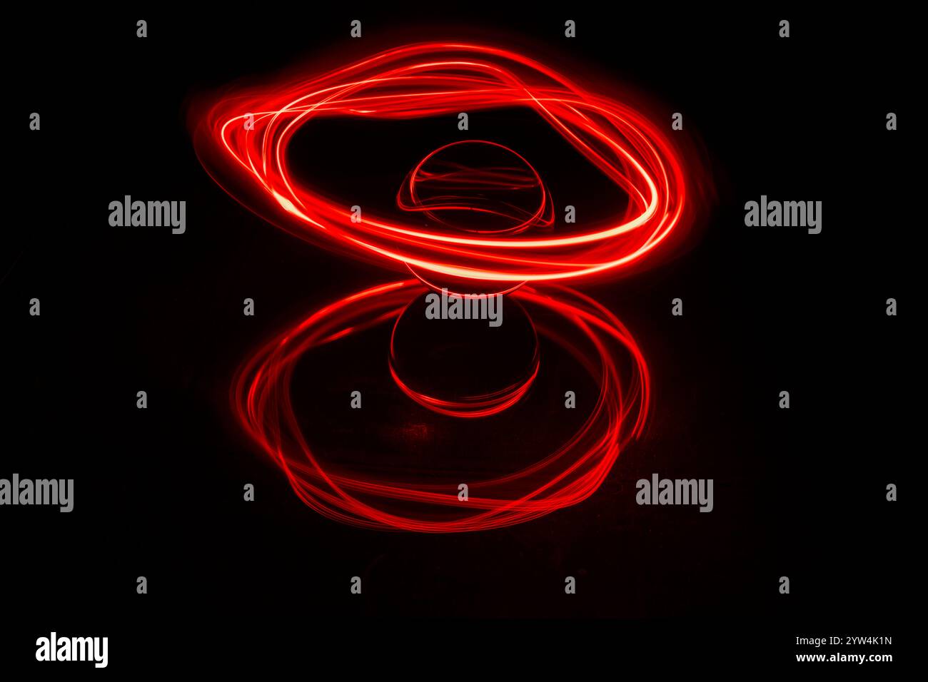 Abstract red light trails created by light painting around a static ...