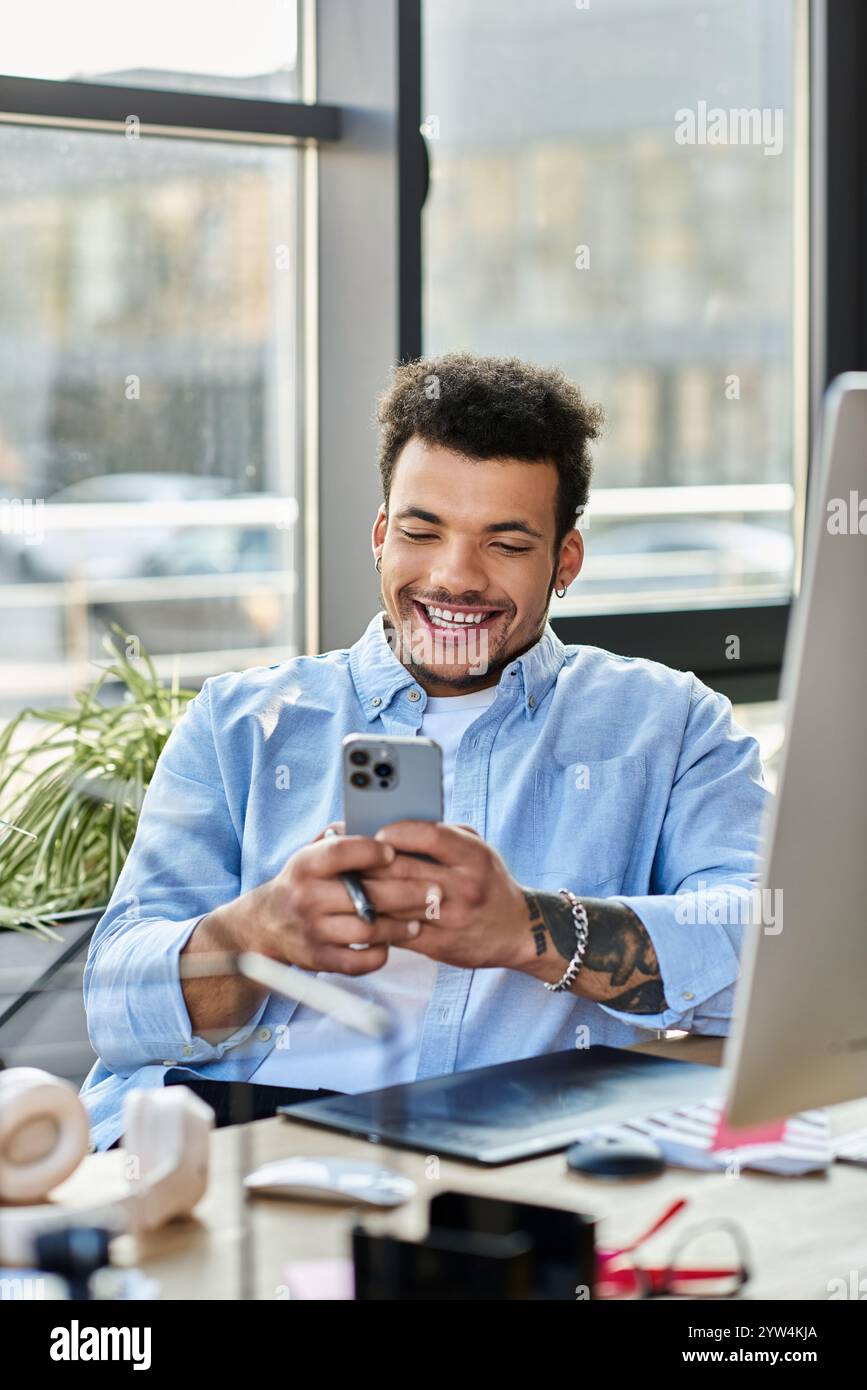A cheerful man smiles widely as he engages with his smartphone at a ...
