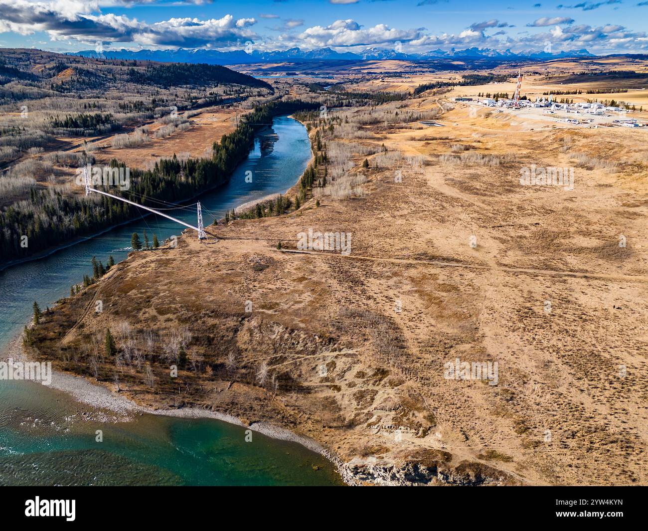 Natural gas pipeline crossing over river leaving a distant gas plant ...