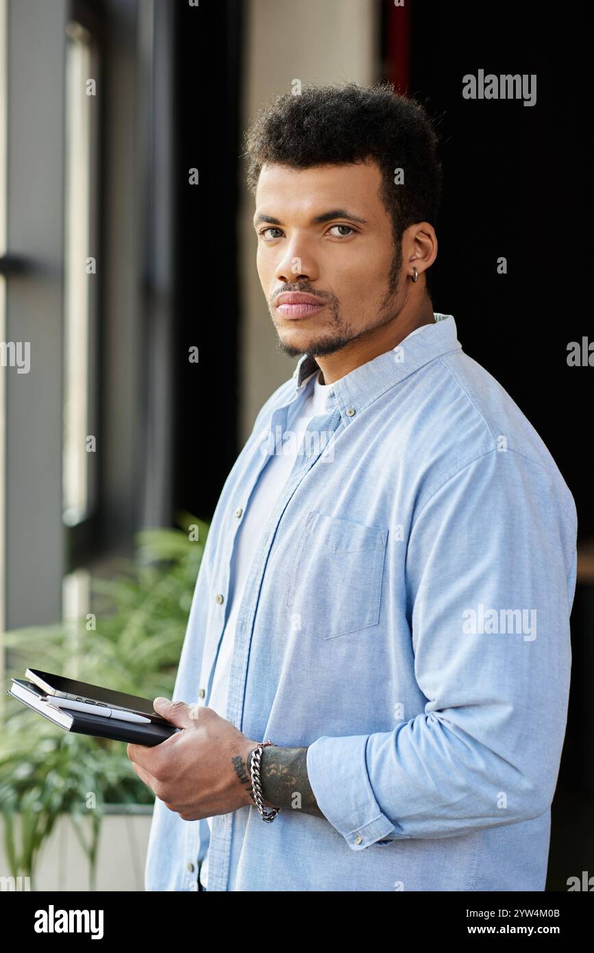 Confident individual with a charming look engages with his notebook ...