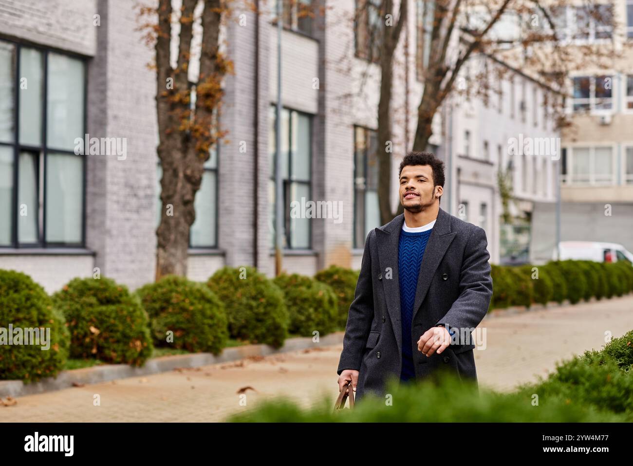A dapper man walks confidently down the tree lined street, enjoying the ...