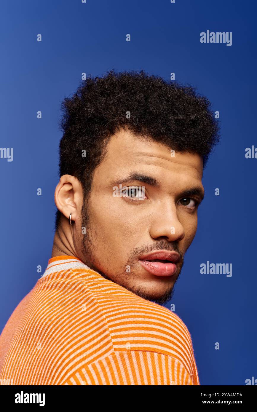 A charming man showcases his captivating expression while looking over ...