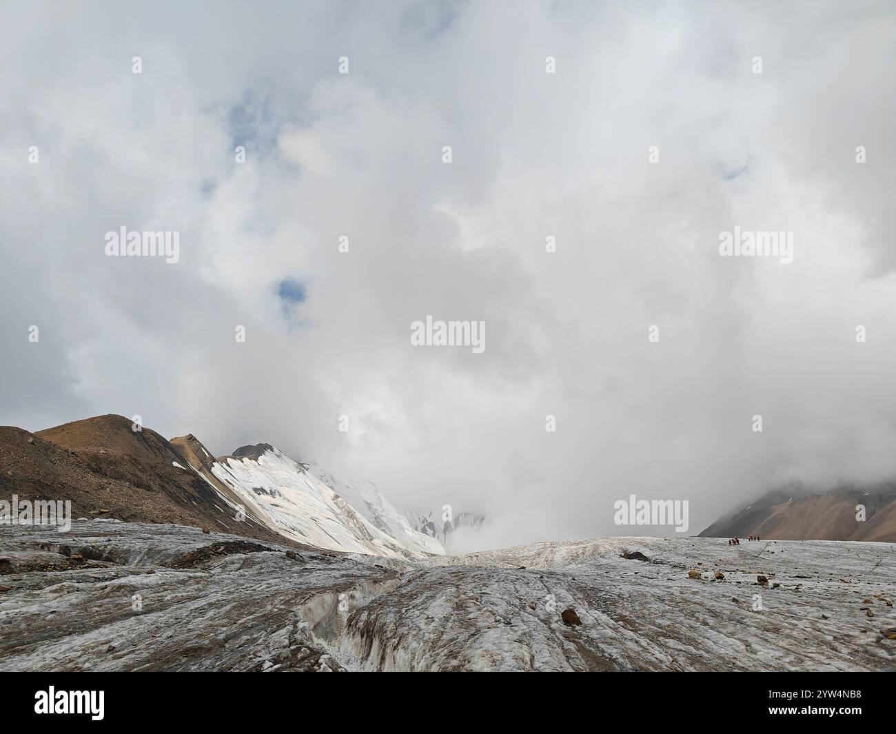 A breathtaking glacier stretches across the landscape, with rugged ...
