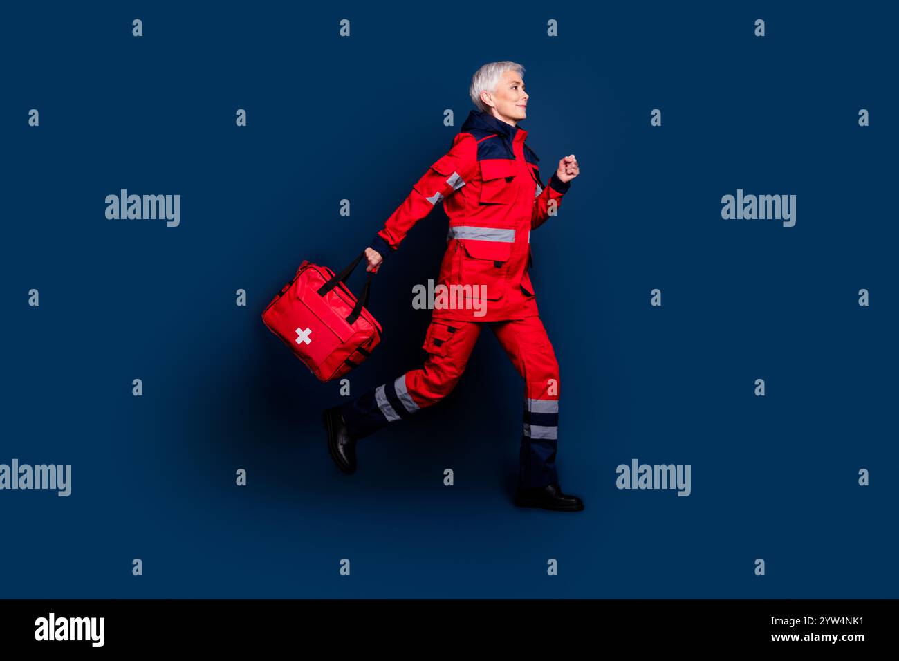 Full body photo of senior woman ambulance worker first aid kit bag ...