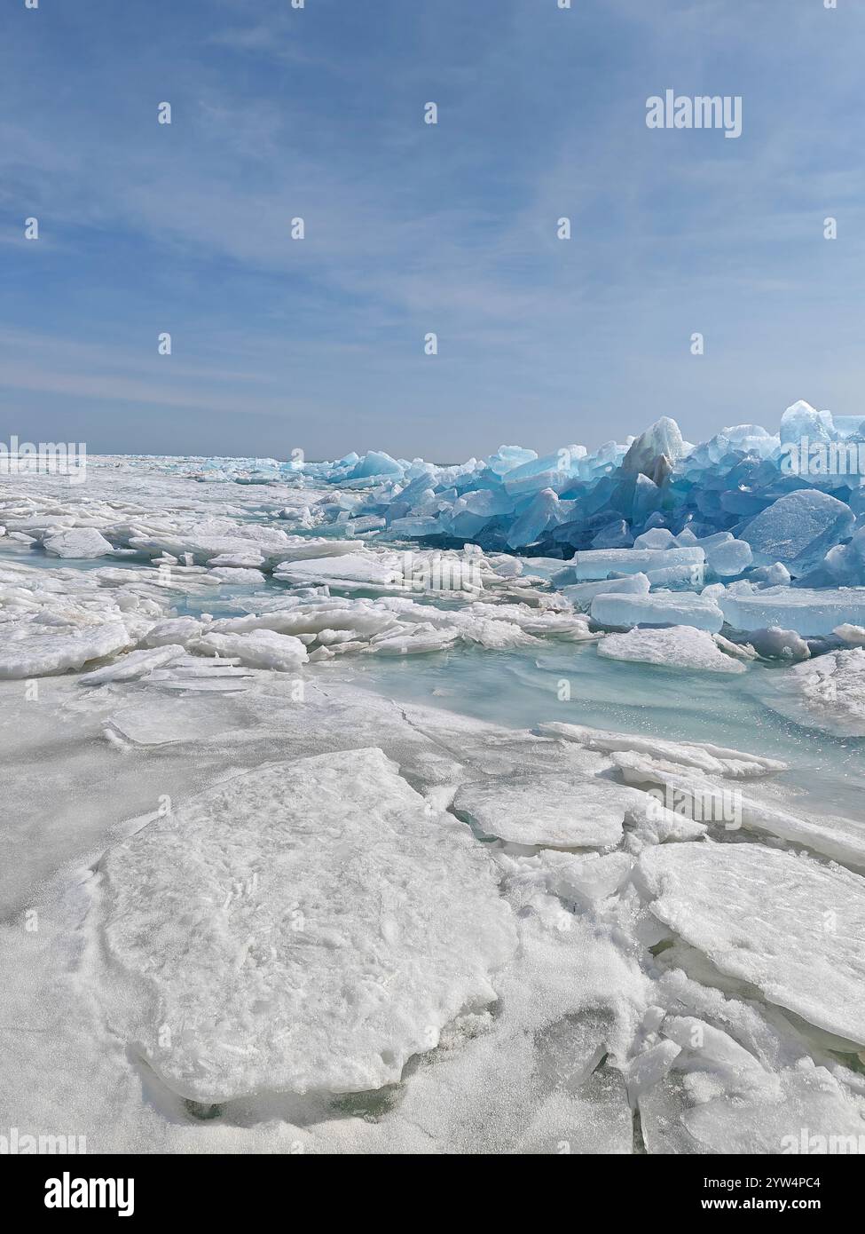 Vast icy terrain features large blue icebergs and melting ice sheets ...