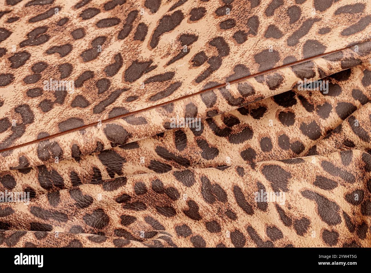 Leopard print fabric with bold black spots on tan background with ...
