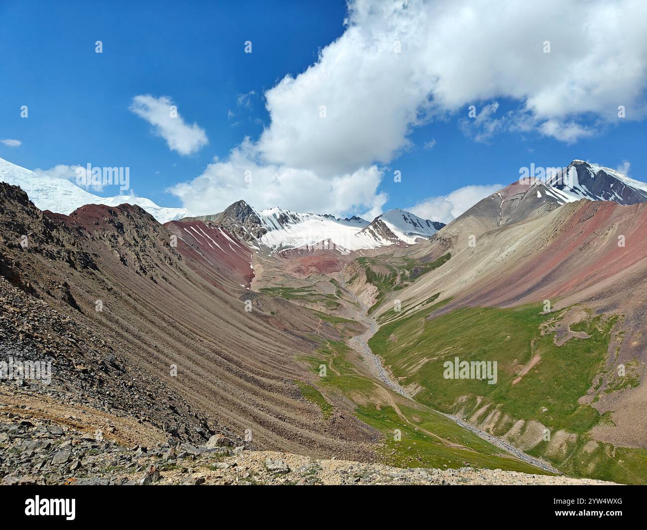 Dramatic view of colorful mountain ridges and green valleys set against ...