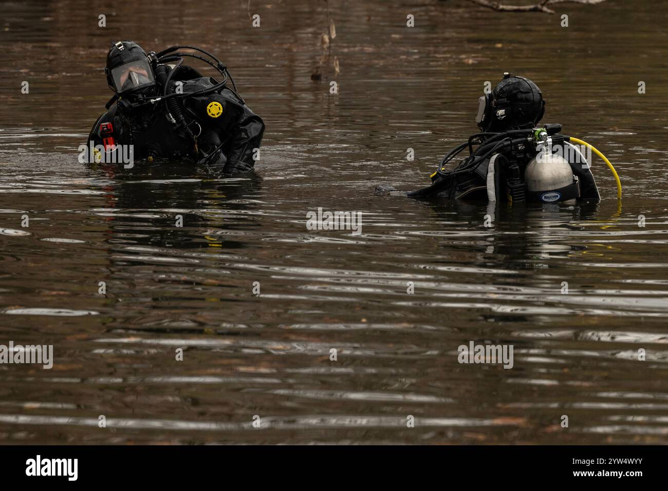 NYPD officers in diving suits search a lake in Central Park, Monday ...