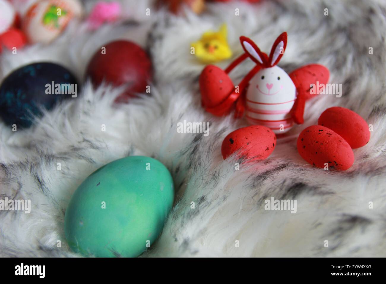 Vibrant Easter eggs and a cute bunny figure Stock Photo - Alamy