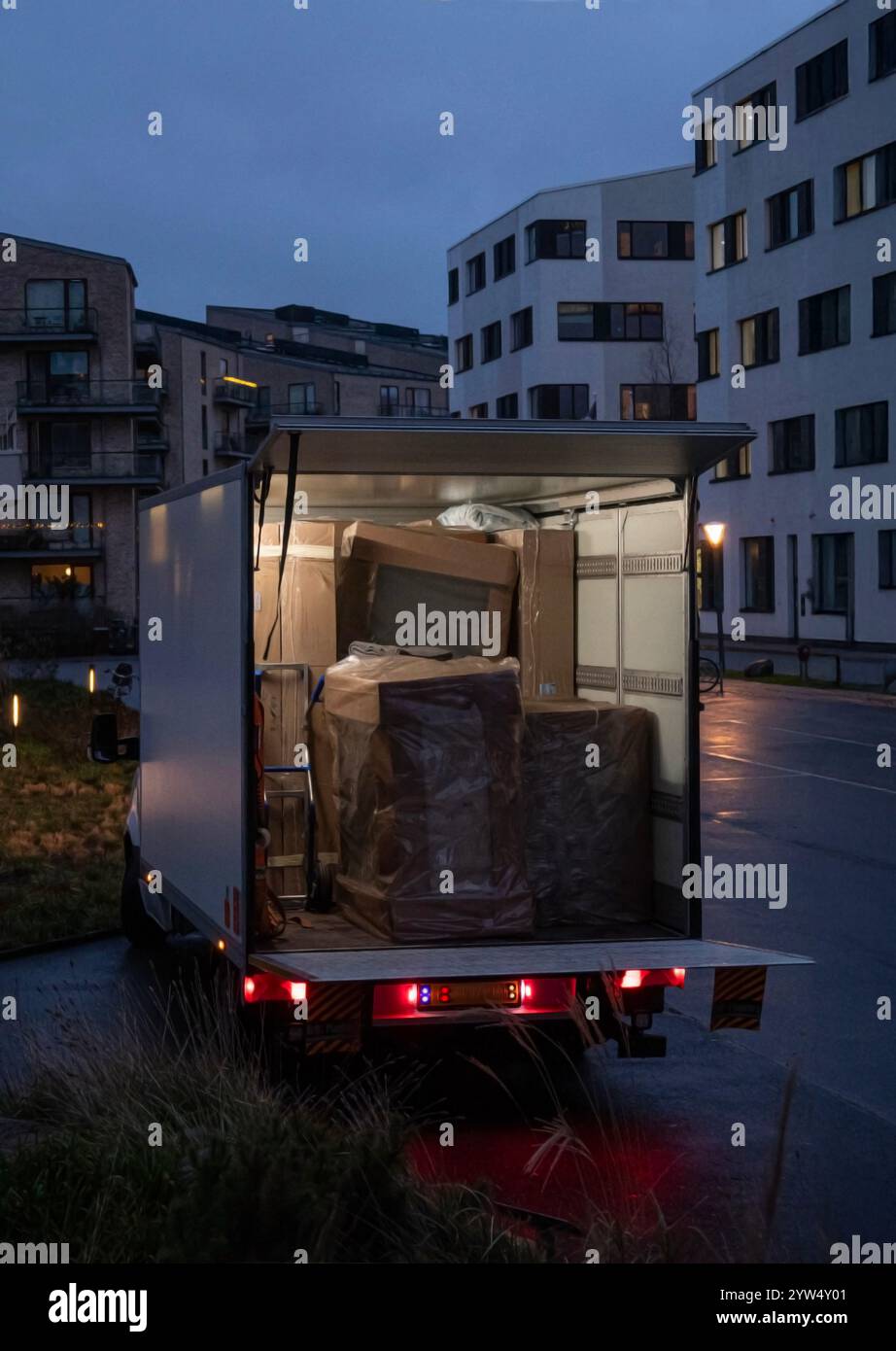 Delivery truck at night with tailgate loader open in front of a ...