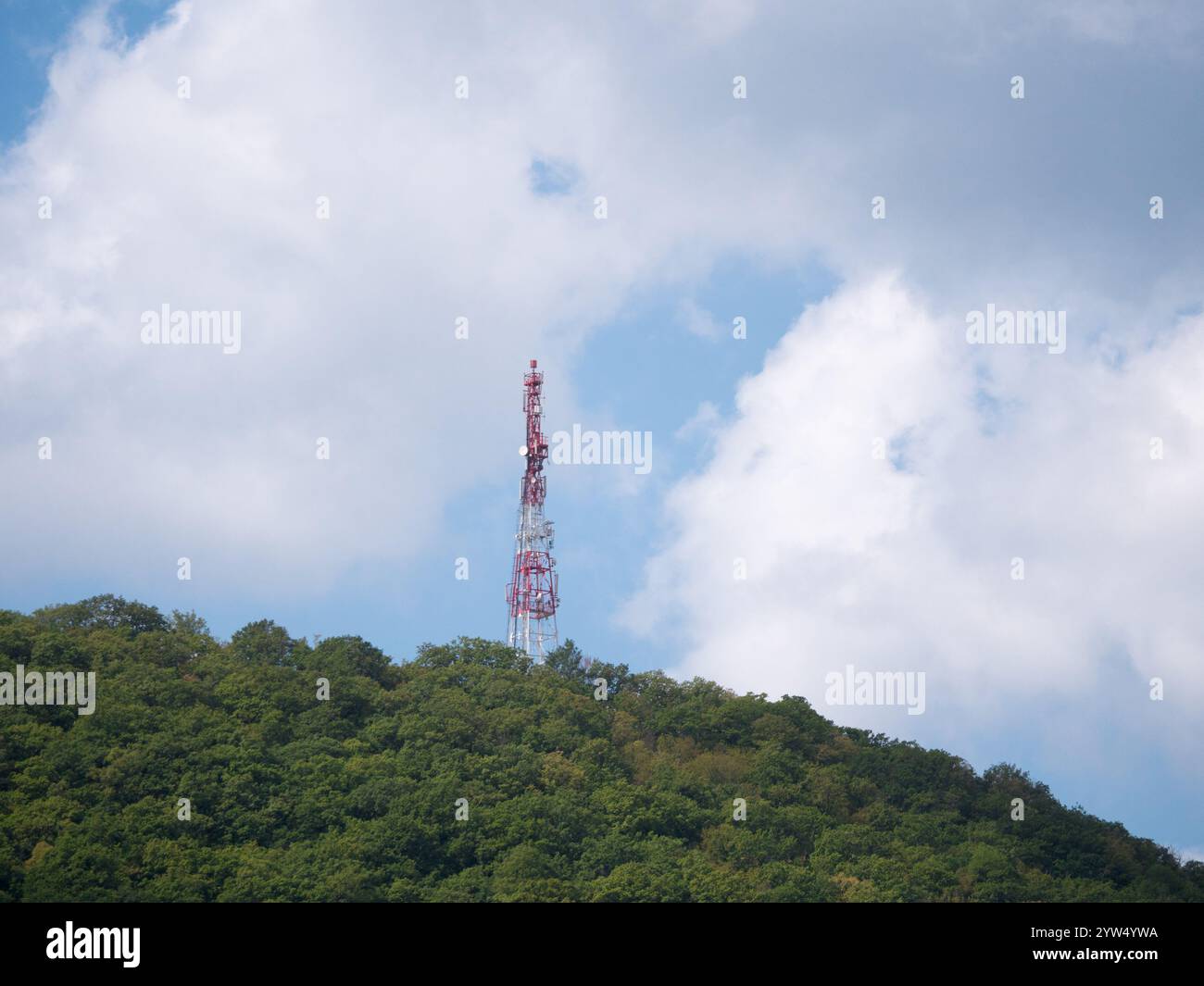 Directional antenna array on a red and white communication tower ...