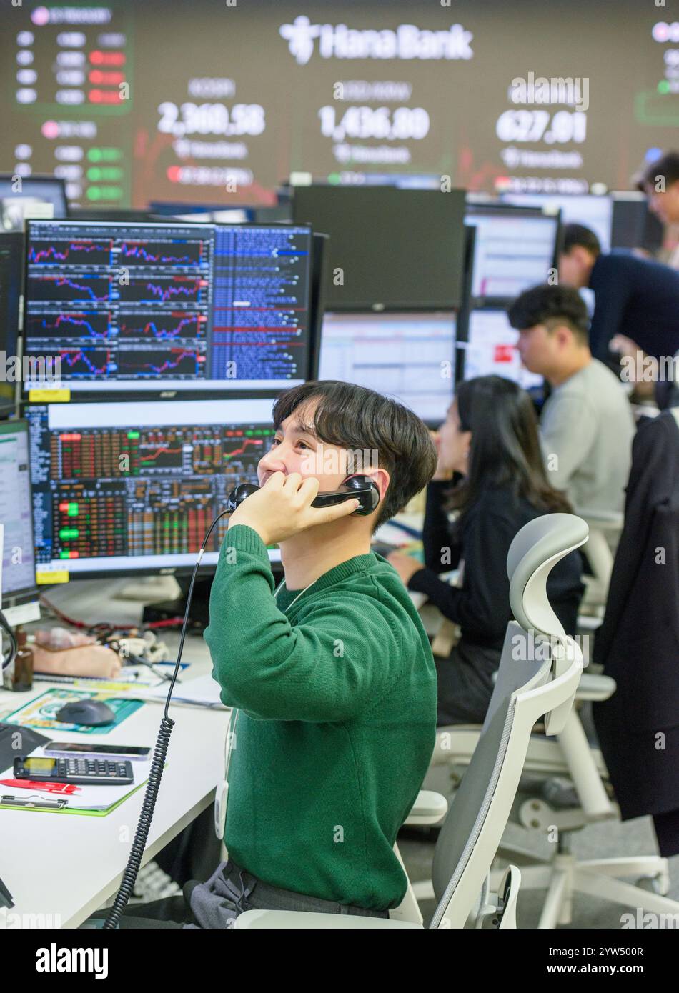 Currency traders look at the monitors at the foreign exchange dealing room of the KEB Hana Bank ...