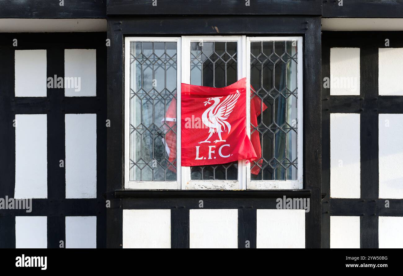 Liverpool Football Club (L.F.C) flag draped on a window of a building ...
