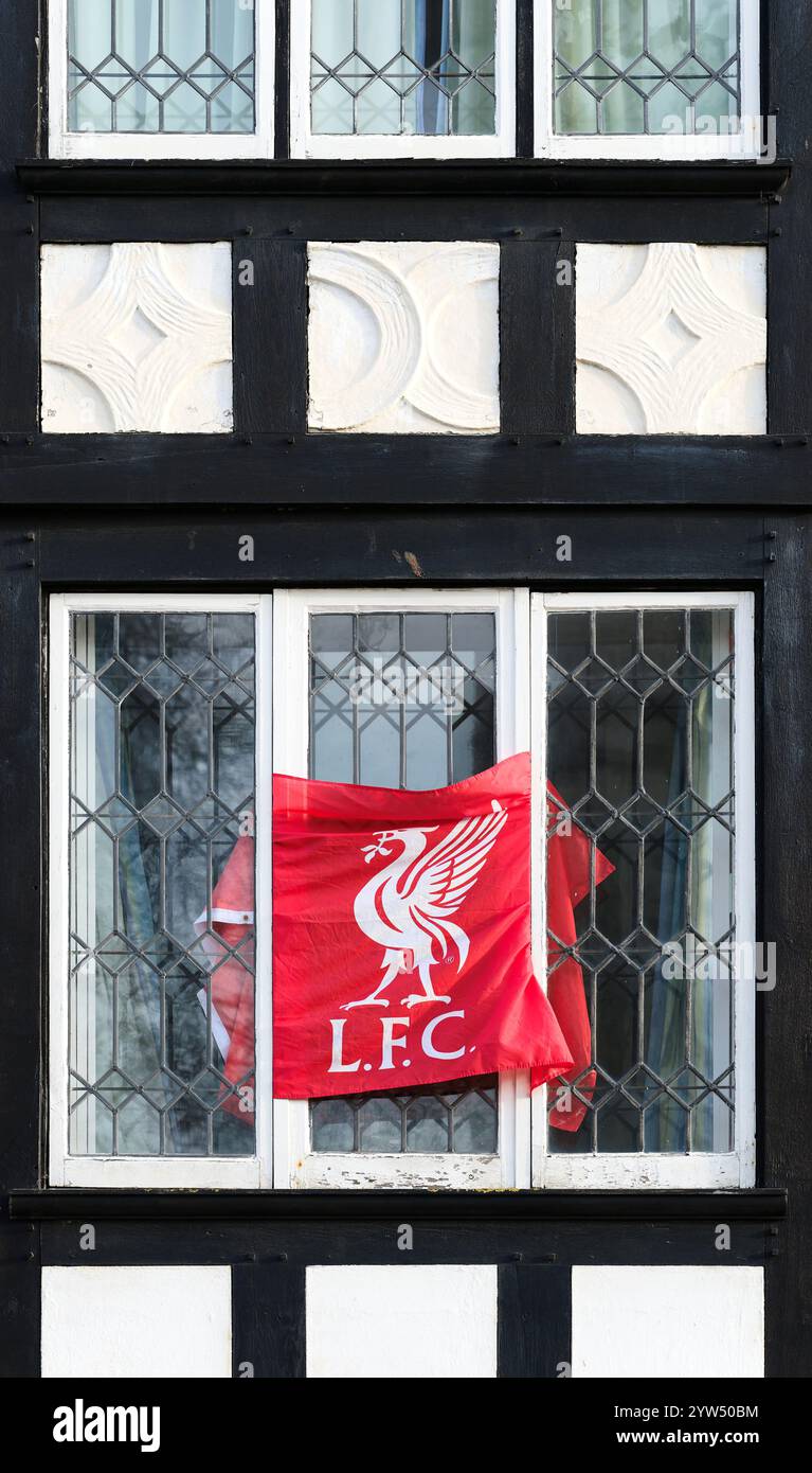 Liverpool Football Club (L.F.C) flag draped on a window of a building ...