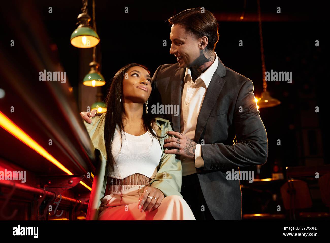 A multicultural couple shares a heartfelt moment during their night out ...