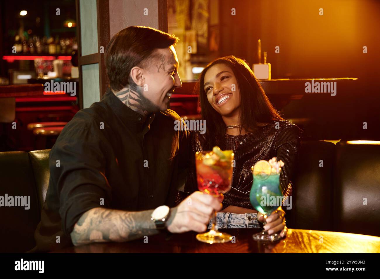 A young couple shares laughter and cocktails while on a delightful ...