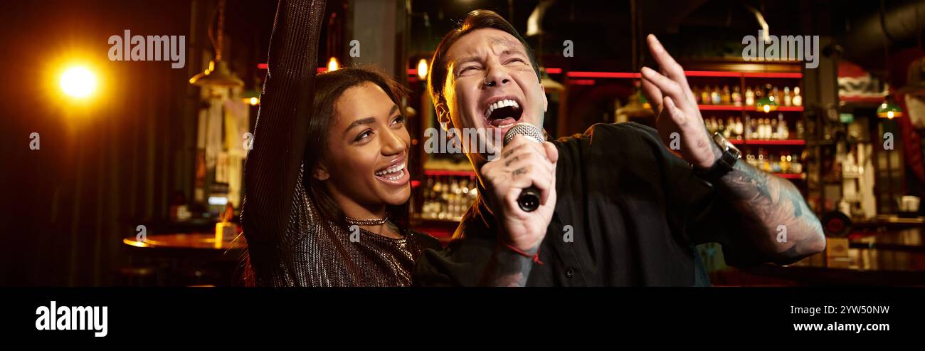 A young couple shares a joyful moment singing together on stage during ...