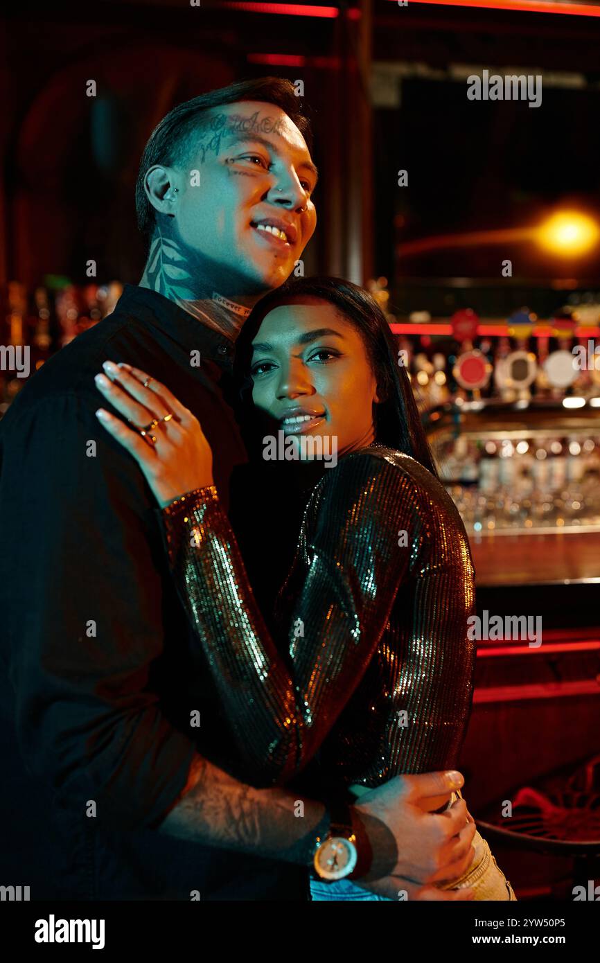 A young couple shares a warm embrace at a lively bar, enjoying their ...