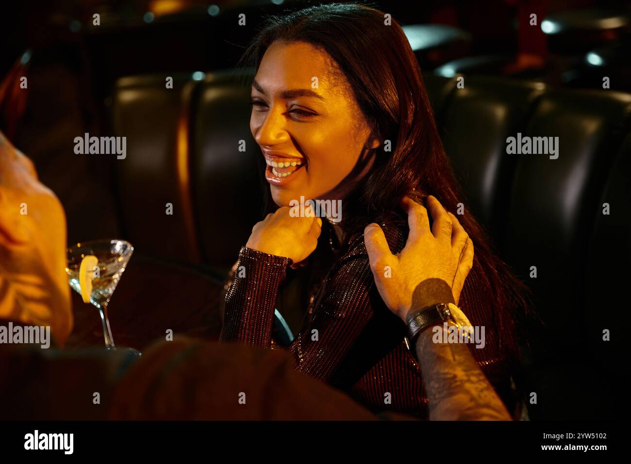 A young couple shares laughter and connection over drinks in a vibrant ...