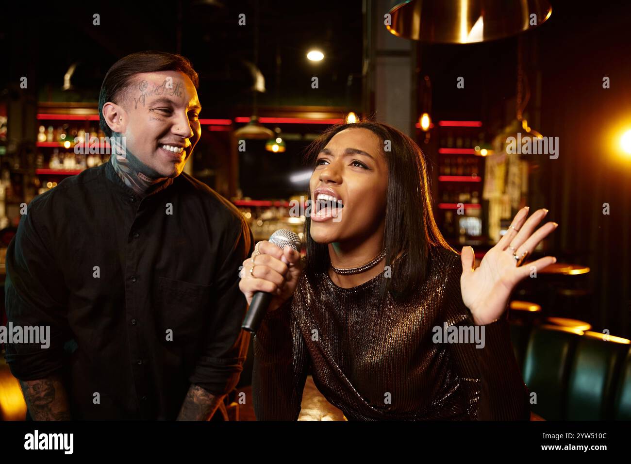 A young couple shares laughter and music while enjoying their night out ...