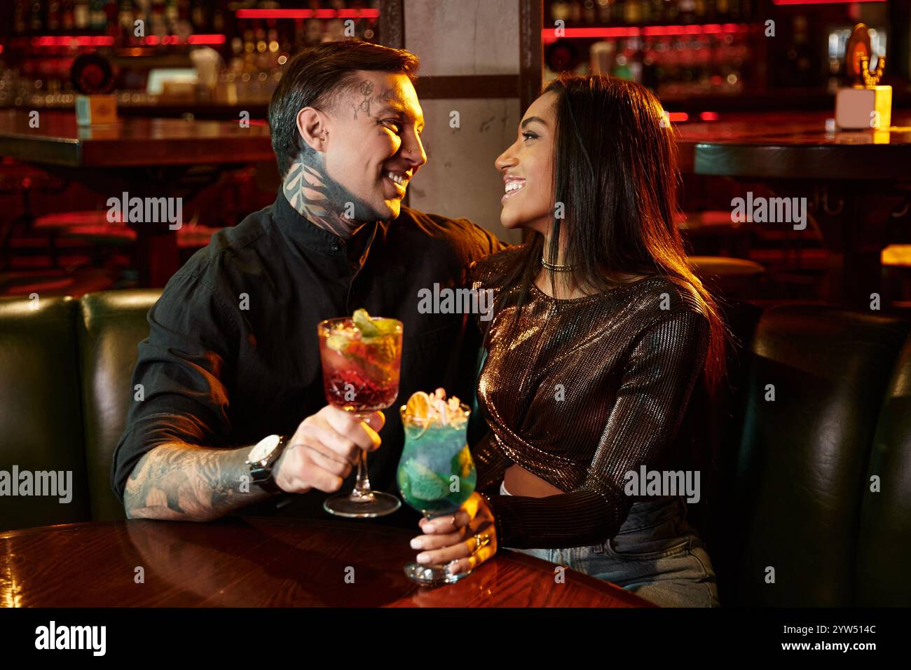 Tattooed couple shares laughs and cocktails during a lively evening at ...