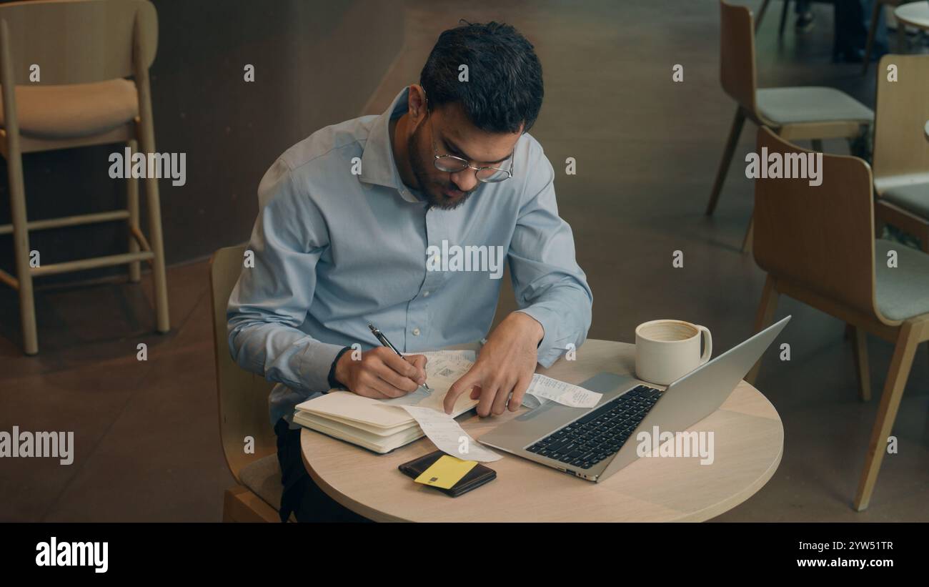 Arabian Indian business man guy education studying write notes in cafe ...