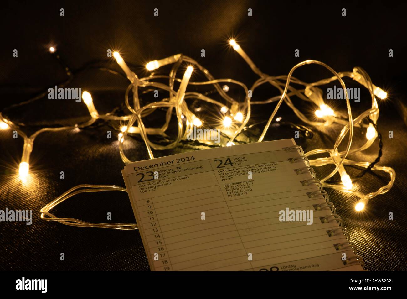Swedish almanac unfolded on Christmas Eve in front of a decoration of ...