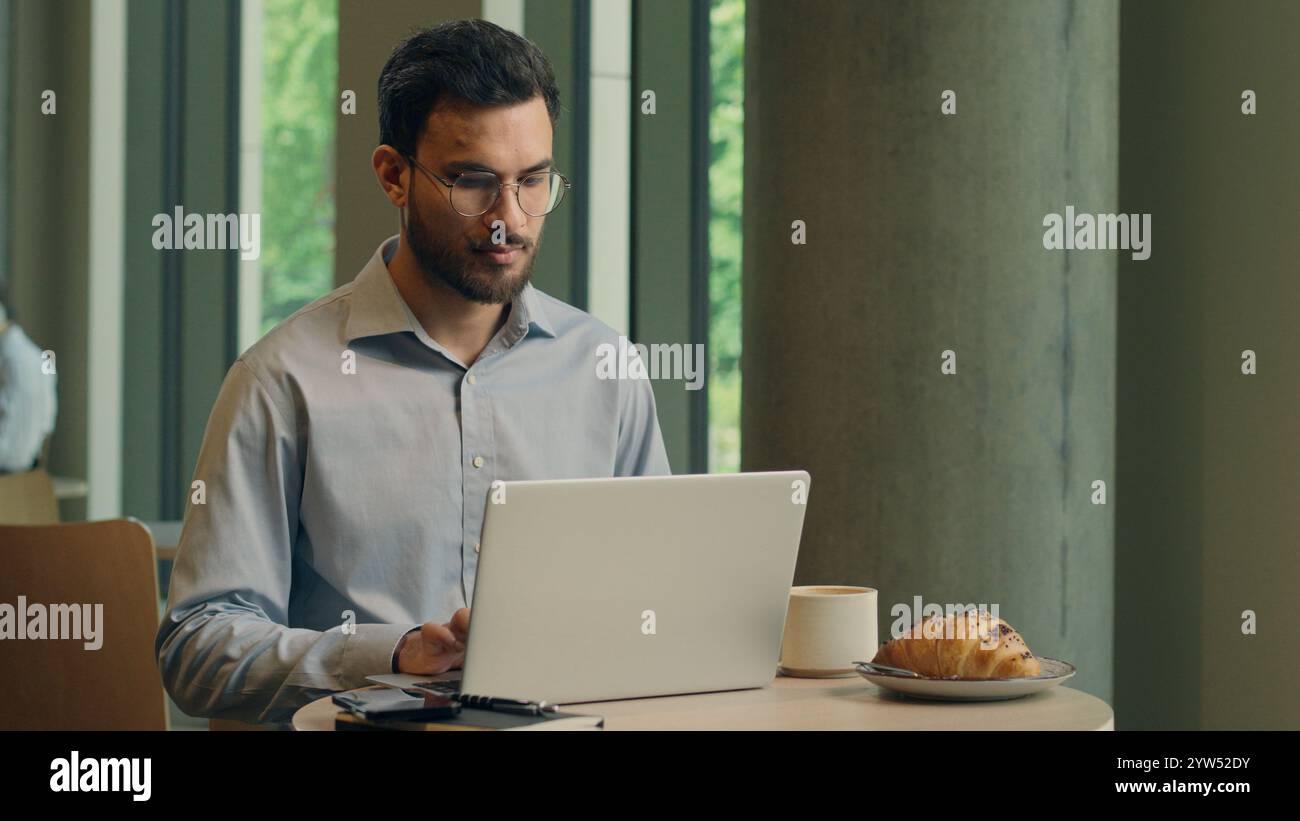 Arabian Indian man typing laptop keyboard concentrated business guy ...